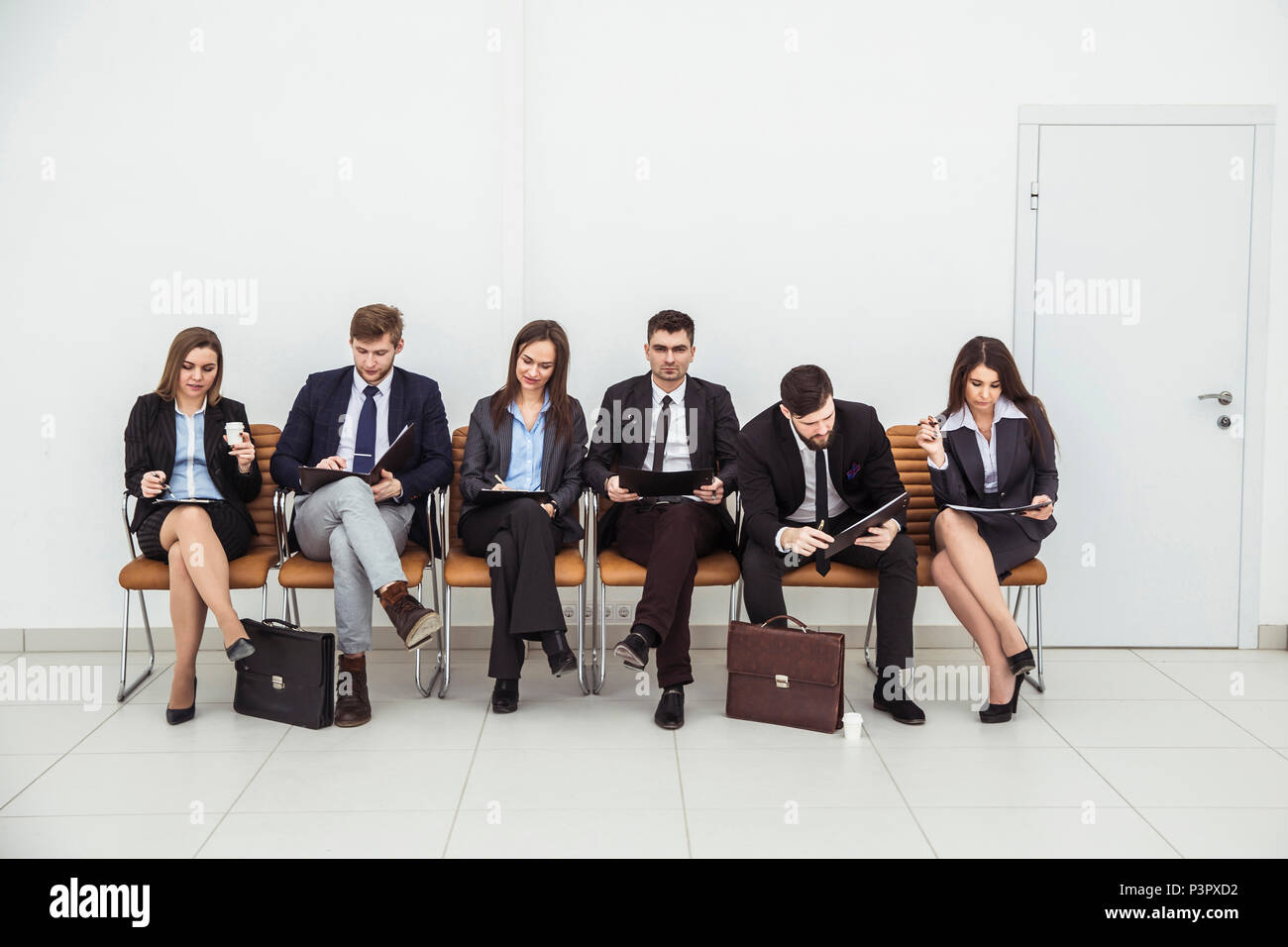business team prepares for the beginning of the presentation sitting in ...