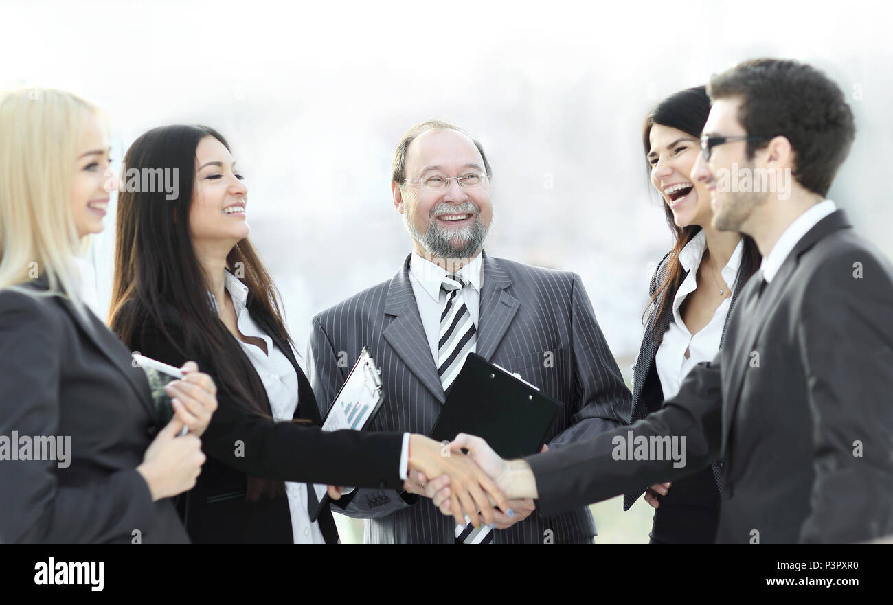 professional business team and shaking hands of young business partners in the office Stock ...