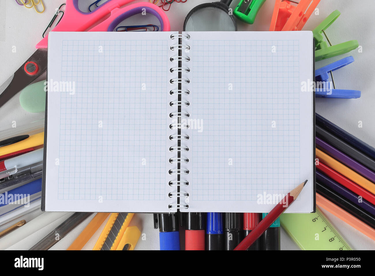 opened Notepad on office supplies on white background Stock Photo - Alamy