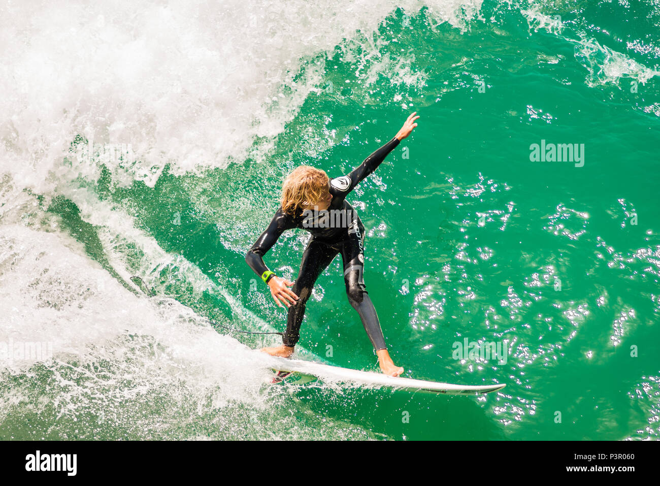 June 25, 2017 - North Beach California : A young teen man rides his ...