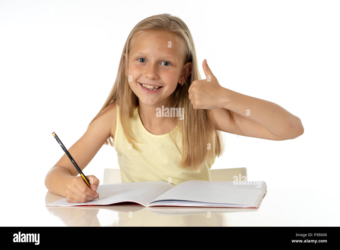 Education at home concept cute young little blonde caucasian girl with thumbs up studying or ...