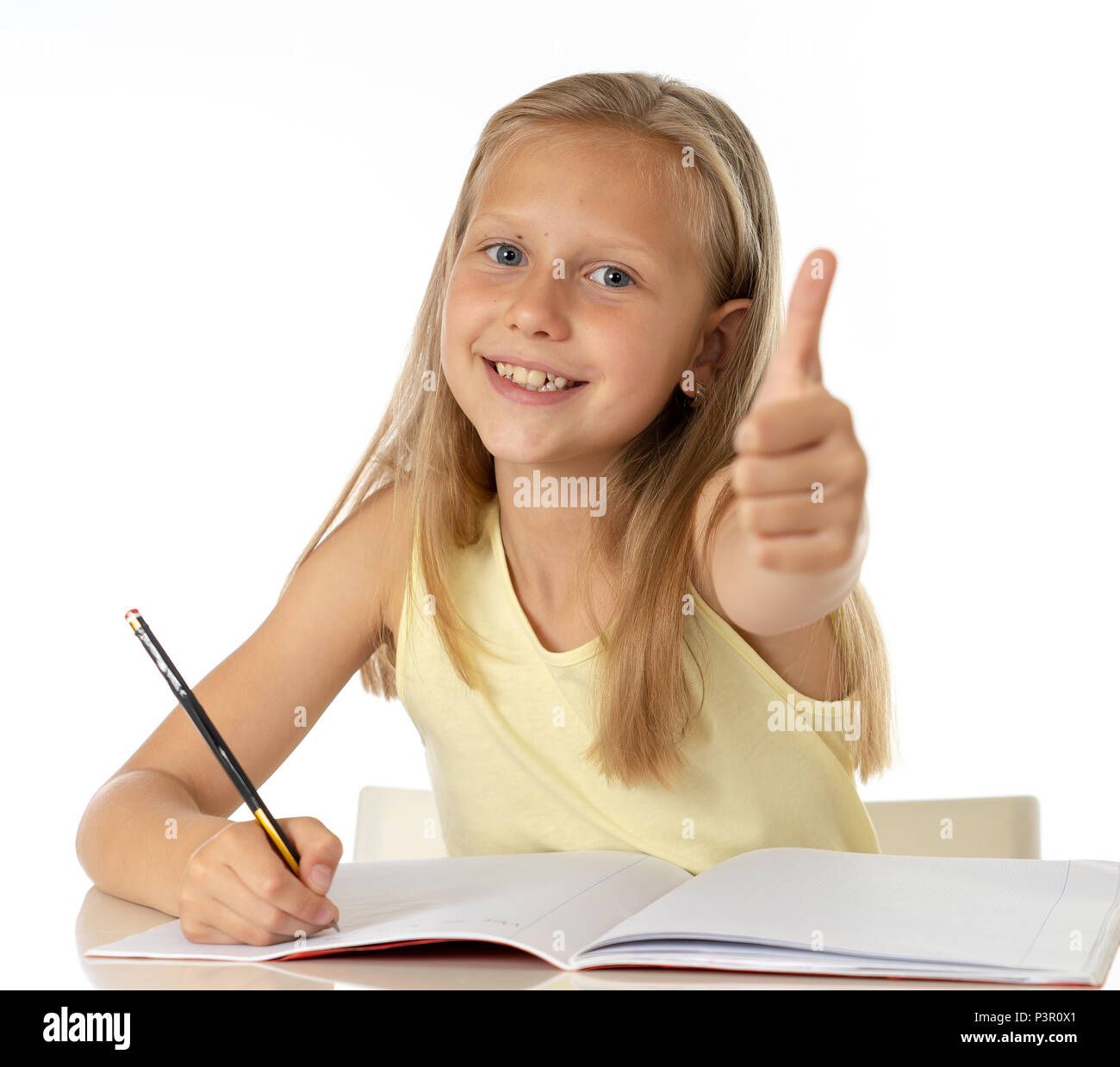 Education at home concept cute young little blonde caucasian girl with thumbs up studying or ...