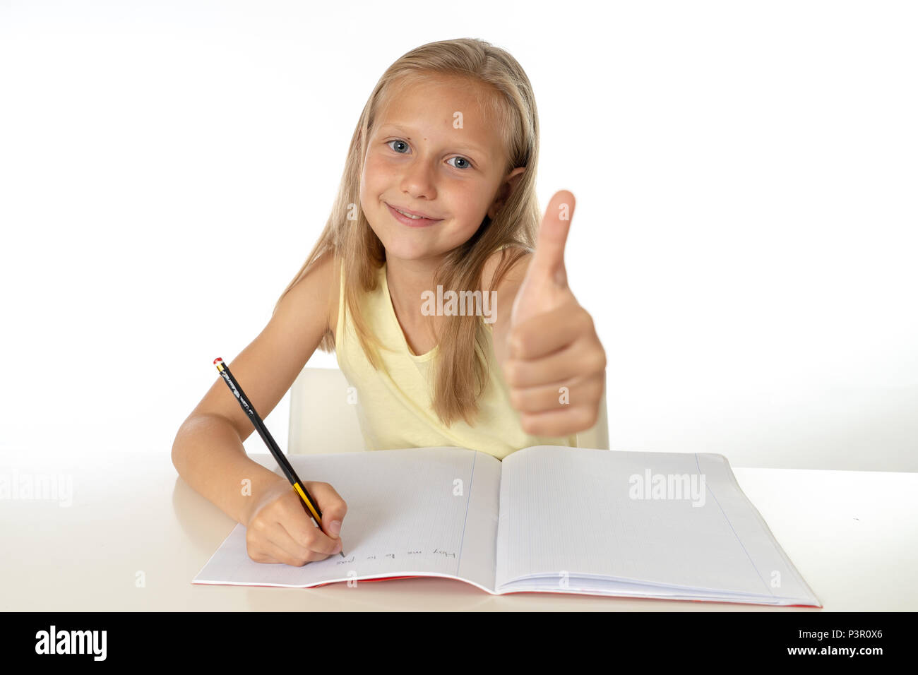 Education at home concept cute young little blonde caucasian girl with thumbs up studying or ...