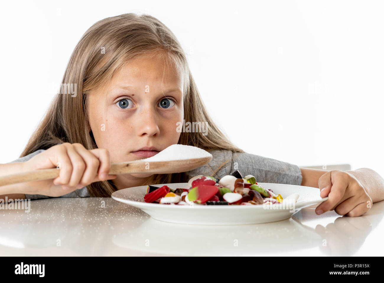 sad 8 year old female child asking for help eating dish full of candy ...