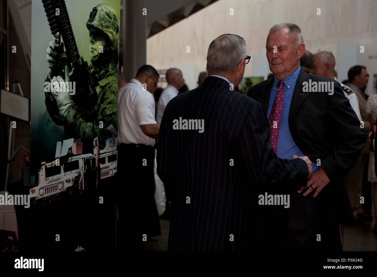 Retired U.S. Marine Corps Lt. Col. Jack Mathews speaks with a guest ...