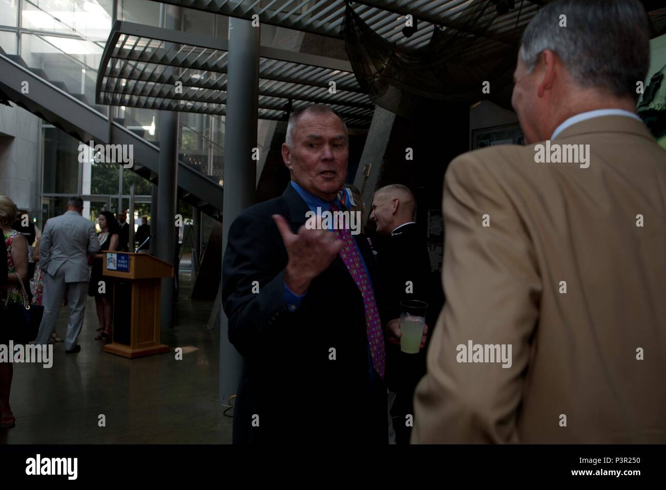 Retired U.S. Marine Corps Lt. Col. Jack Mathews speaks with a guest ...