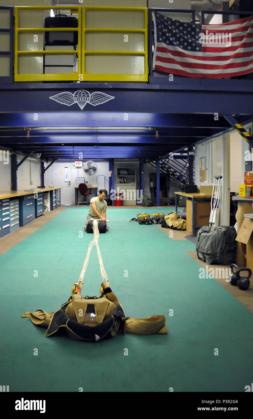 Tech. Sgt. Isaac Shapiro packs a parachute at the 306th Rescue Squadron ...
