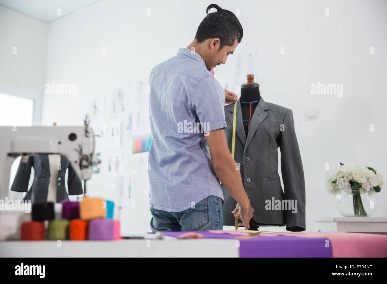 fashion designer make a suit Stock Photo - Alamy
