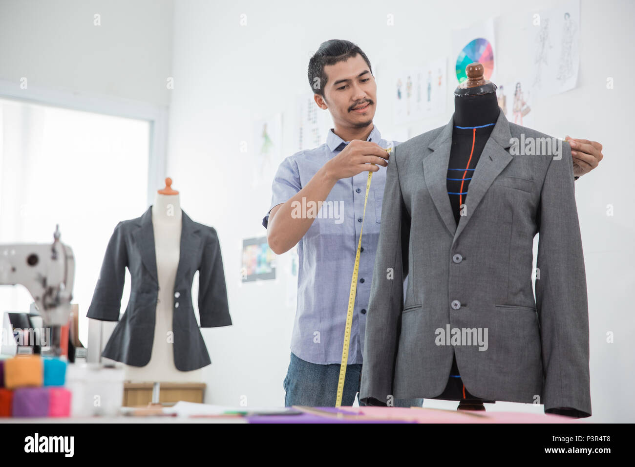 fashion designer make a suit Stock Photo - Alamy