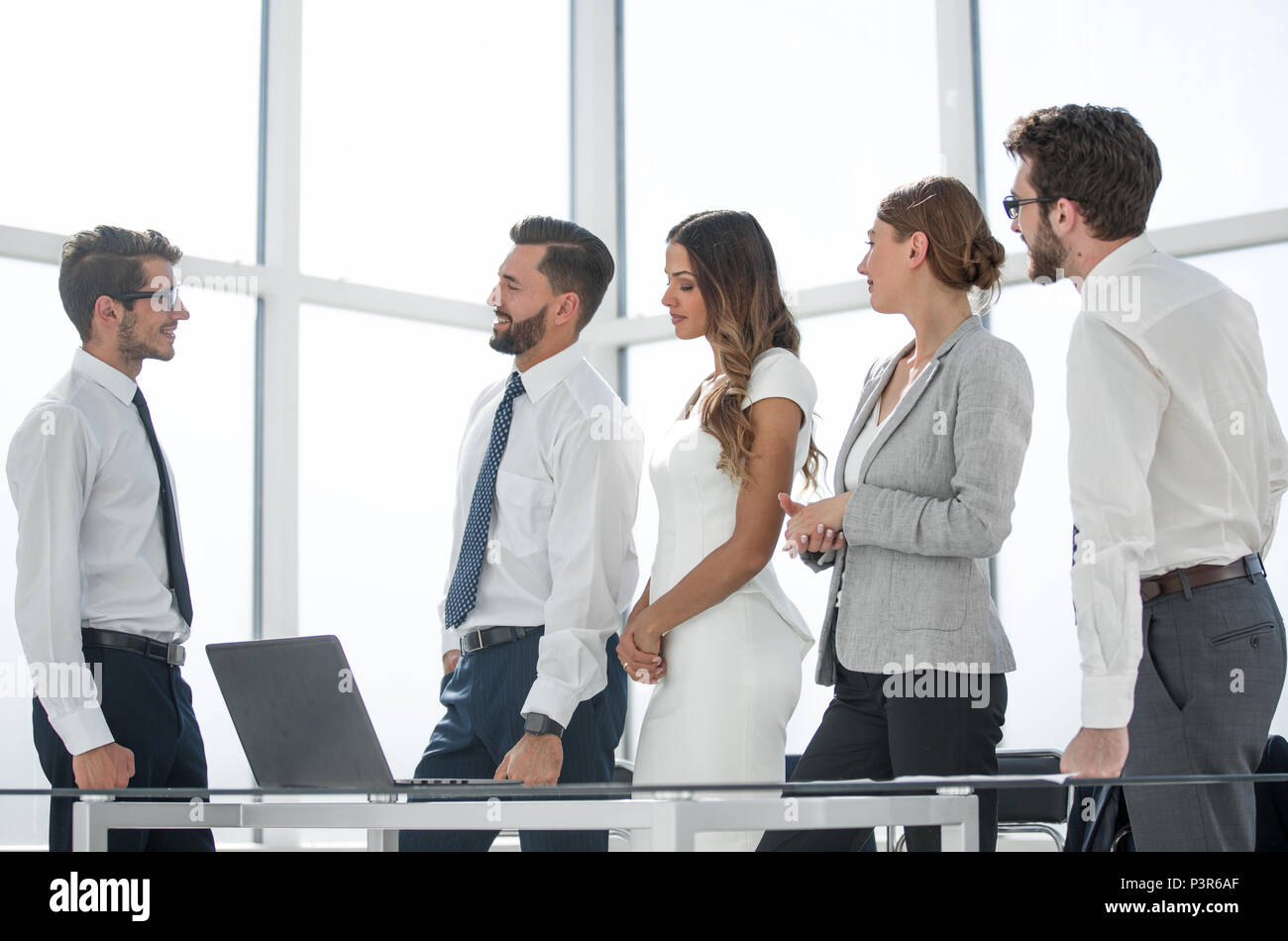 business team looks out the office window Stock Photo - Alamy