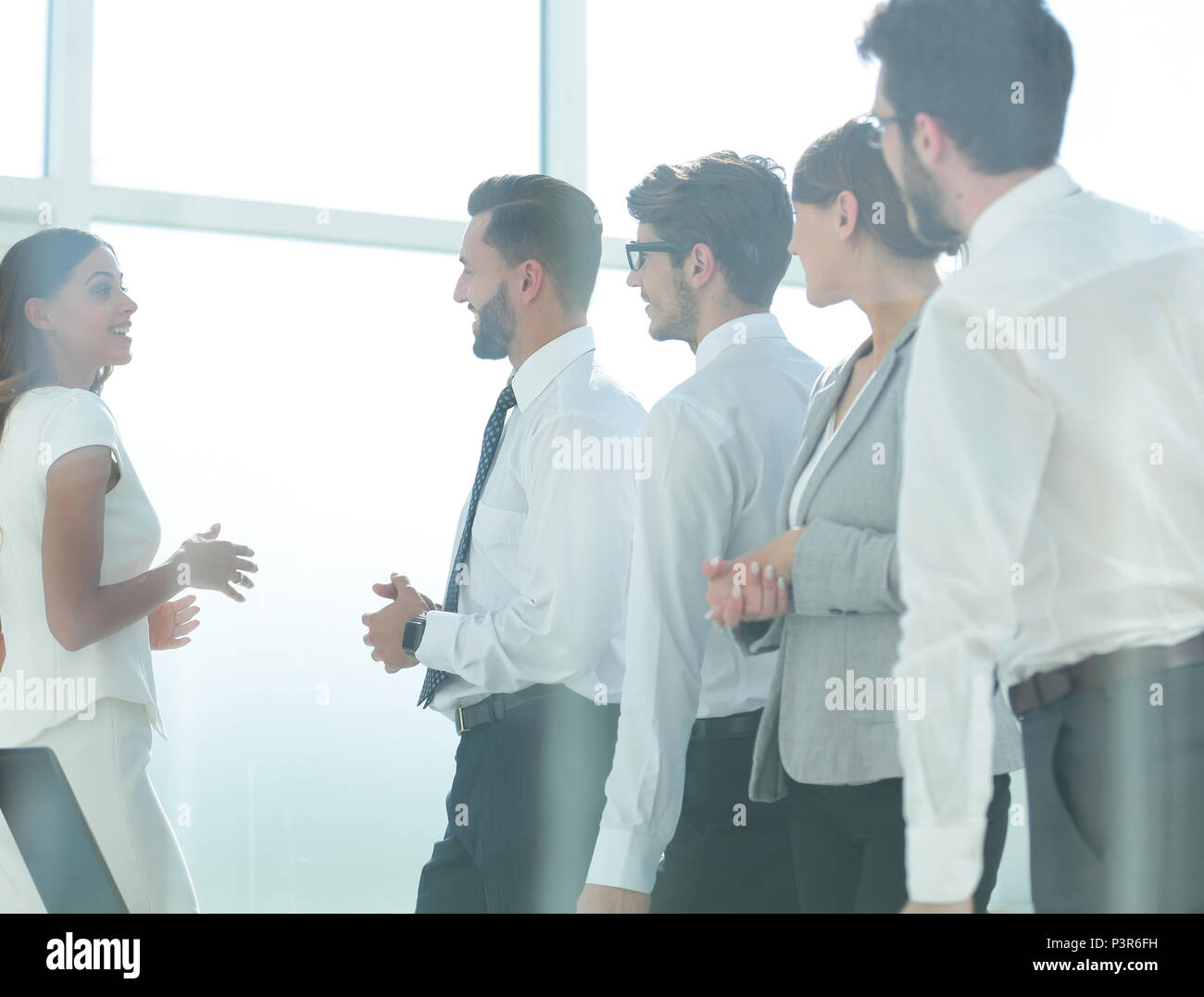 business team looks out the office window Stock Photo - Alamy