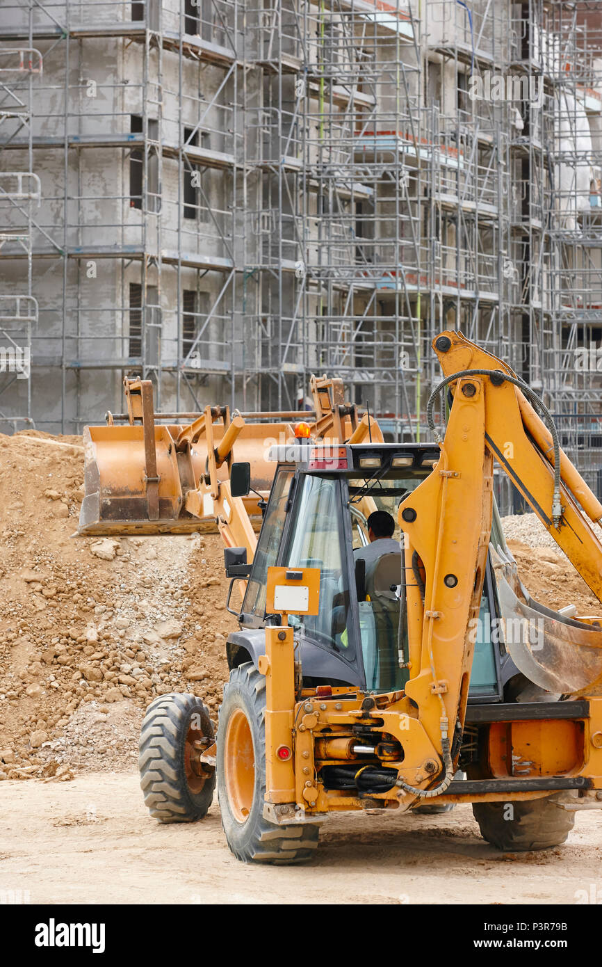 Excavator on a construction site. Building in progress. Architecture ...