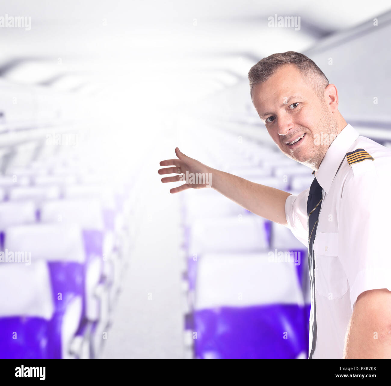 Smiling captain invites you to the plane Stock Photo - Alamy