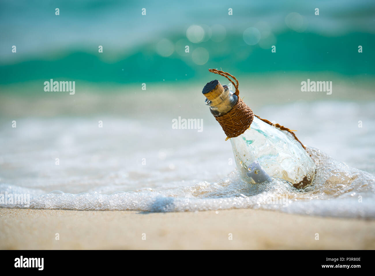 Letter message in a glass transparent bottle on the beach , concept for ...