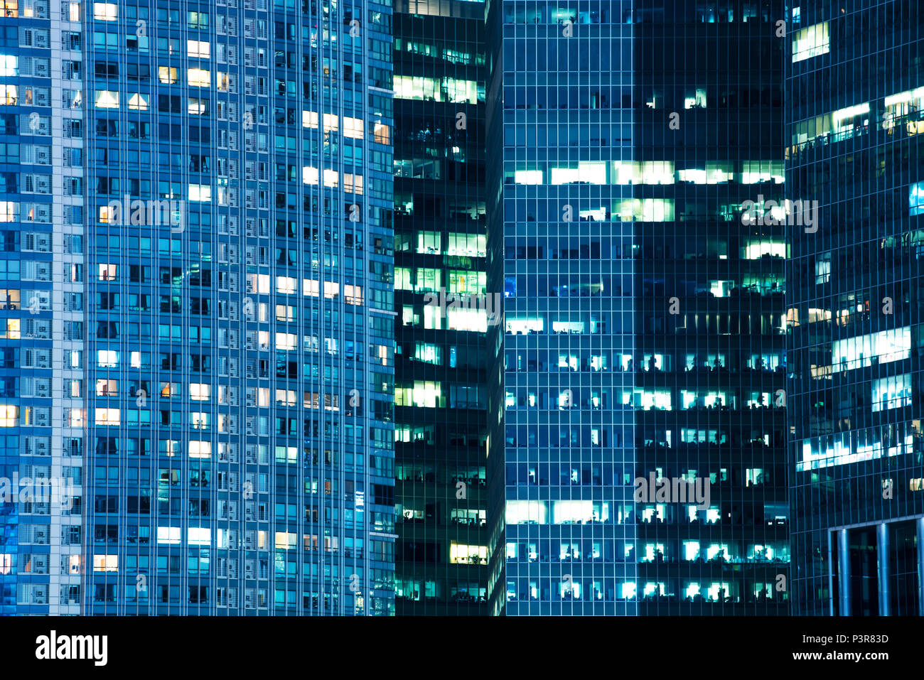 Glass facade of modern city high rise, buildings show lighting using by ...