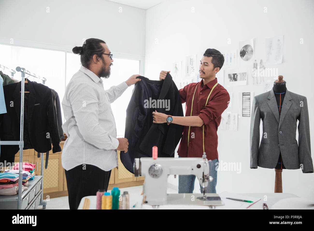 tailor with his customer talking Stock Photo - Alamy
