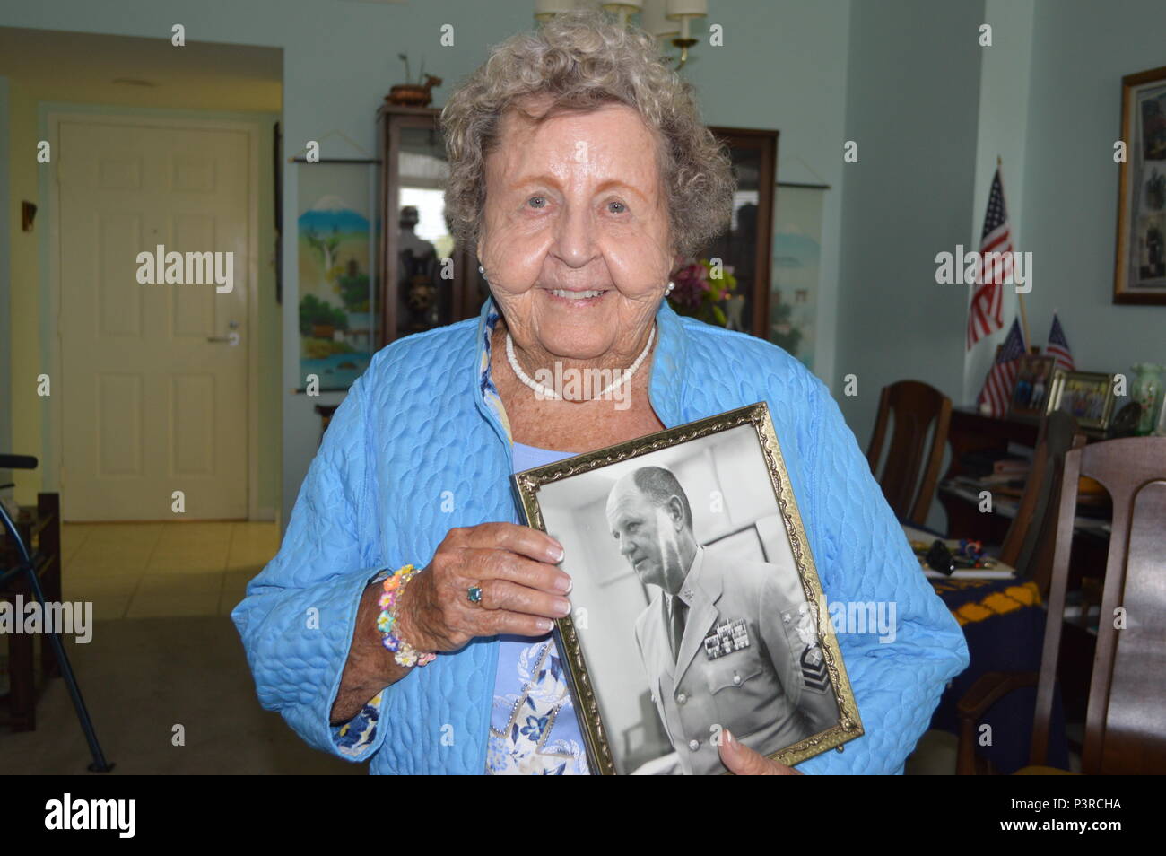 Mrs. Ima Black holds a photo of her late husband, Delbert Black who was ...
