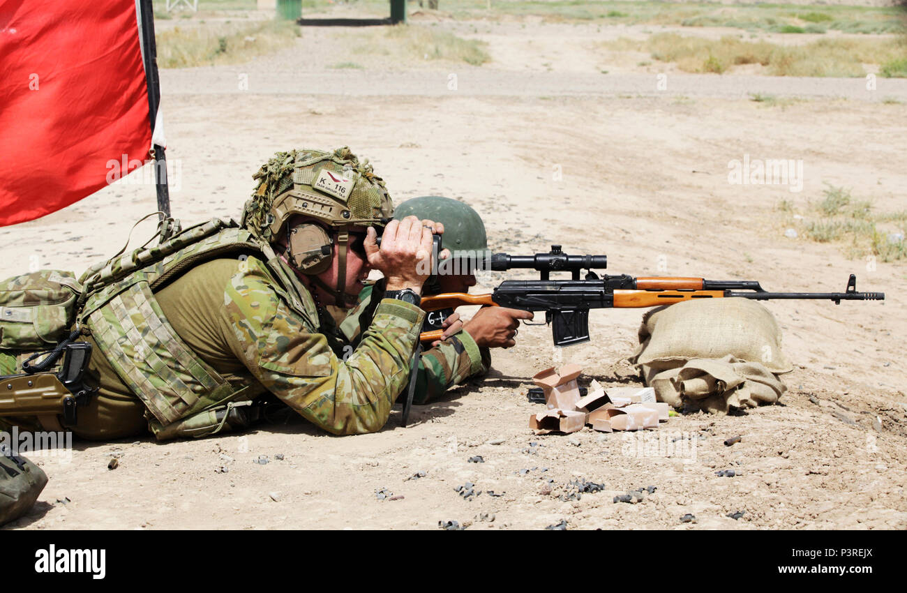 An Iraqi soldier fires a Dragunov sniper rifle as an Australian soldier ...