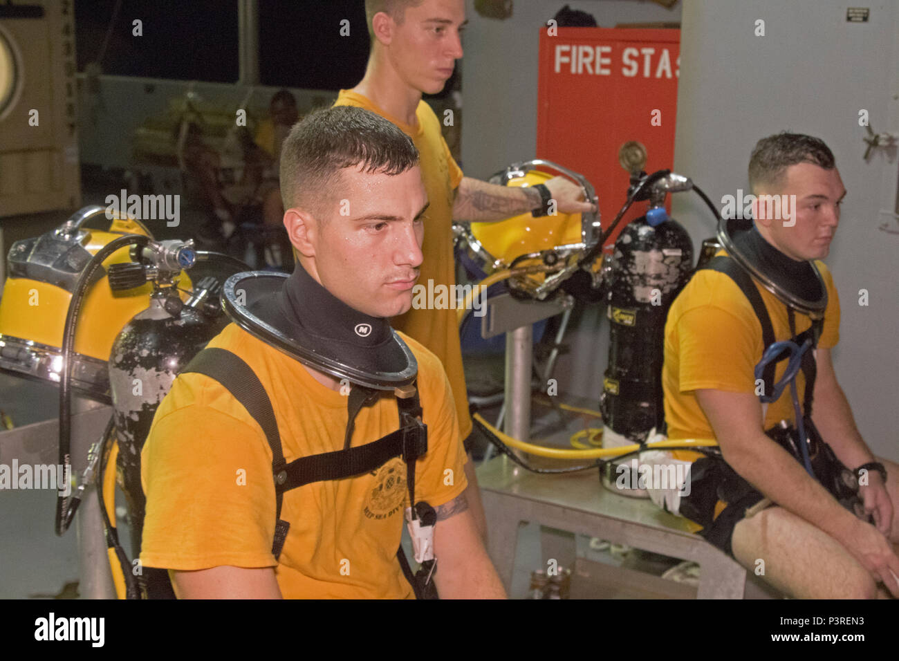 Divers from the 86th Engineer Dive Detachment sit and listen to the ...