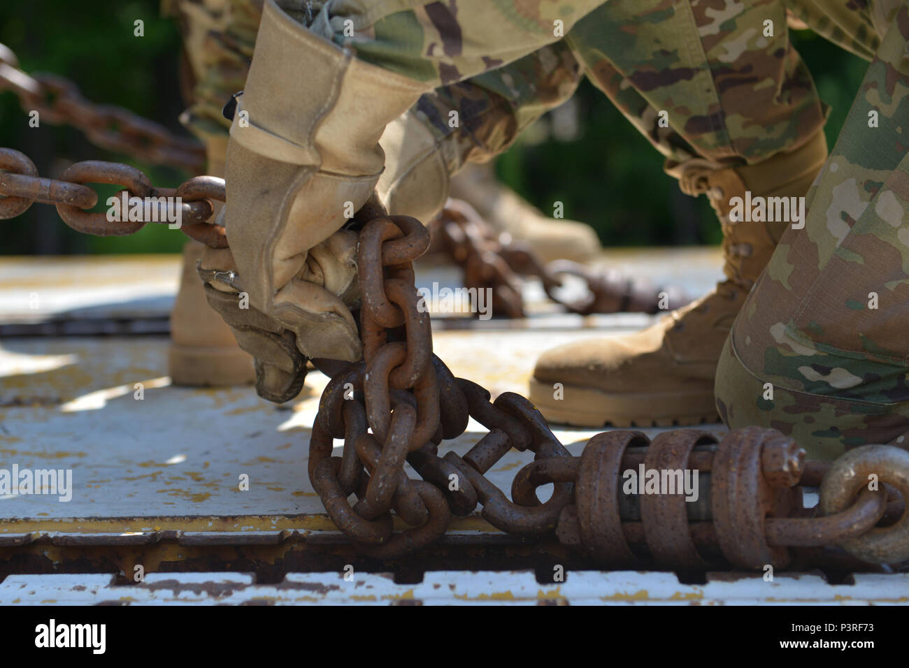 U.S. Army 7th Transportation Brigade (Expeditionary) Soldiers wrench ...