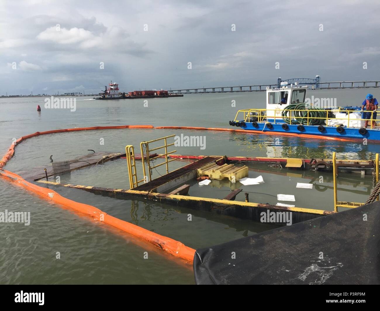 T & T Salvage deploy boom in response to a sunken barge near the ...