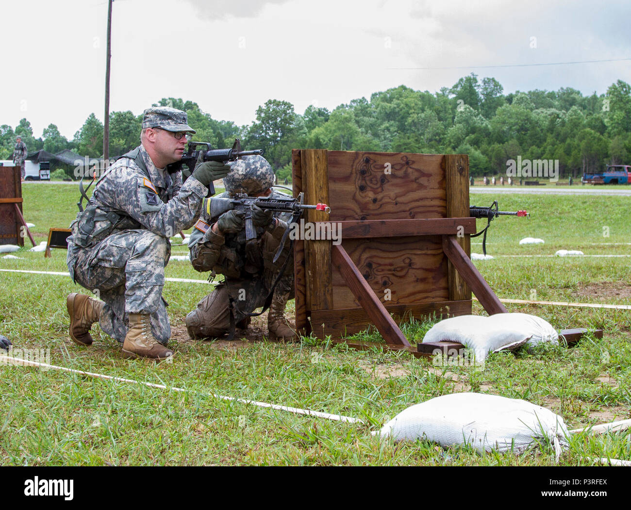 Task Force Wolf, Army Reserve instructor Staff Sgt. Tyler Martin instructs Frantz Pierre, a ...