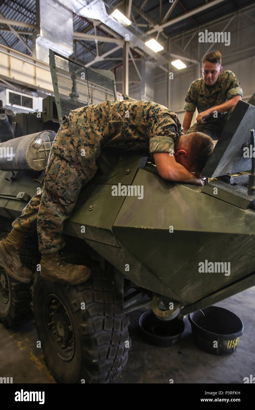 Two Marines with 2nd Maintenance Battalion work on a light armored ...