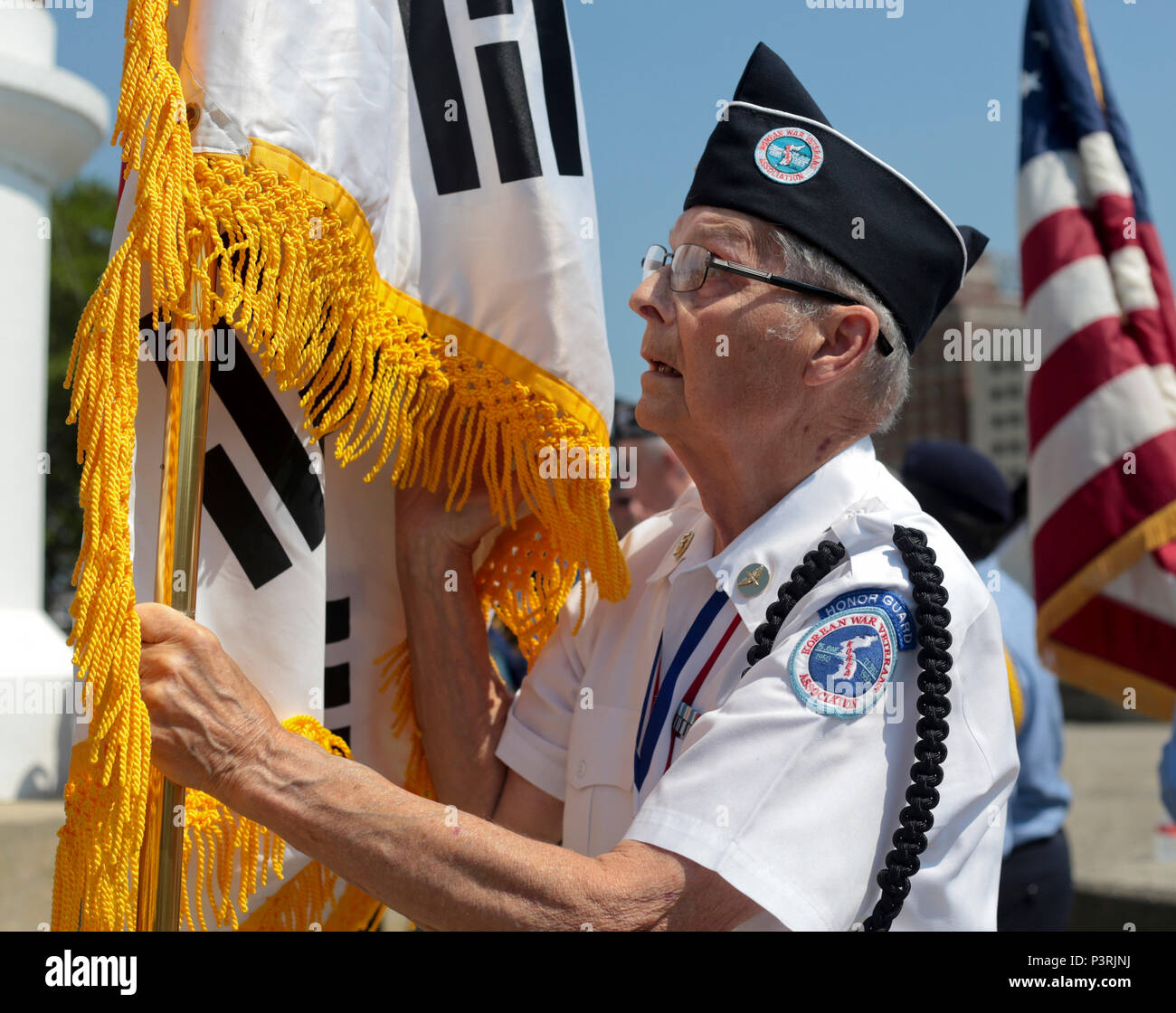 U.S. Air Force veteran John Varallo sets up a Republic of Korea flag ...