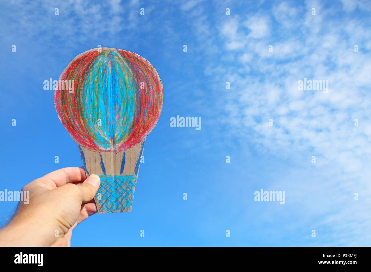 image of male hand holding air balloon against the sky. imagination and ...