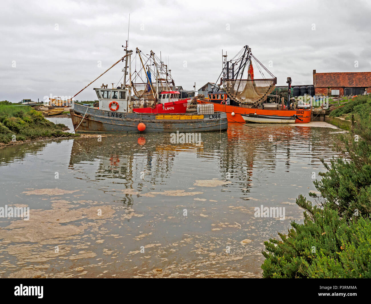 Shrimp boats moored in the little North Norfolk harbour of Brancaster ...