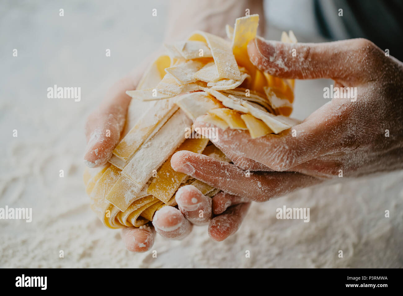Closeup of process of making cooking homemade pasta. Chef make fresh ...