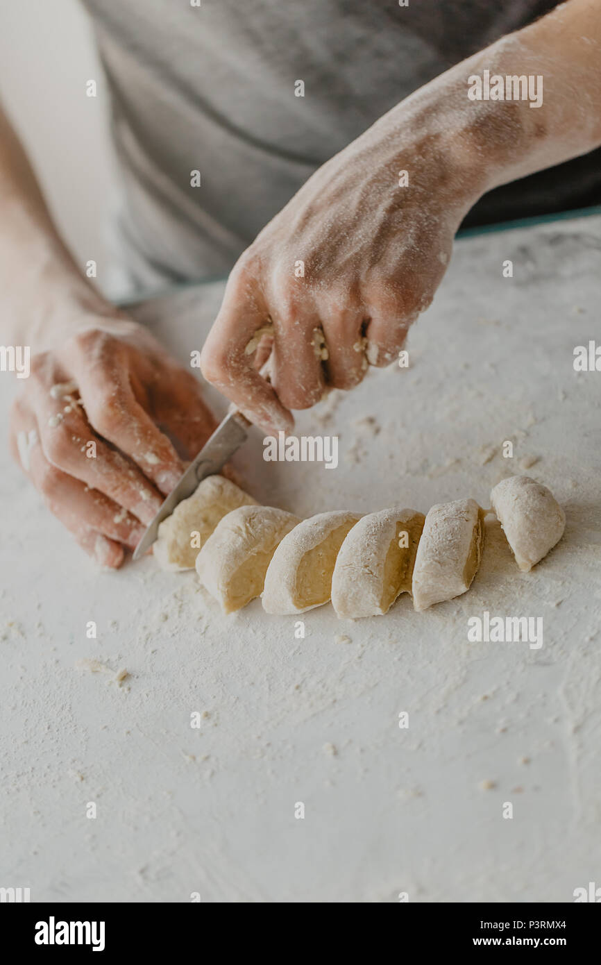 Process of cutting dough making dish cooking homemade dough. Chef makes ...
