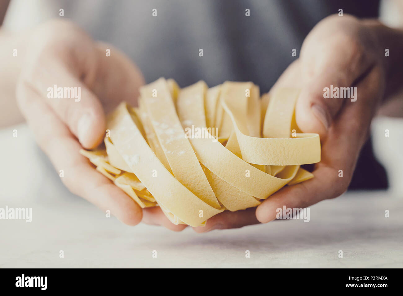 Closeup of process of making cooking homemade pasta. Chef make fresh ...