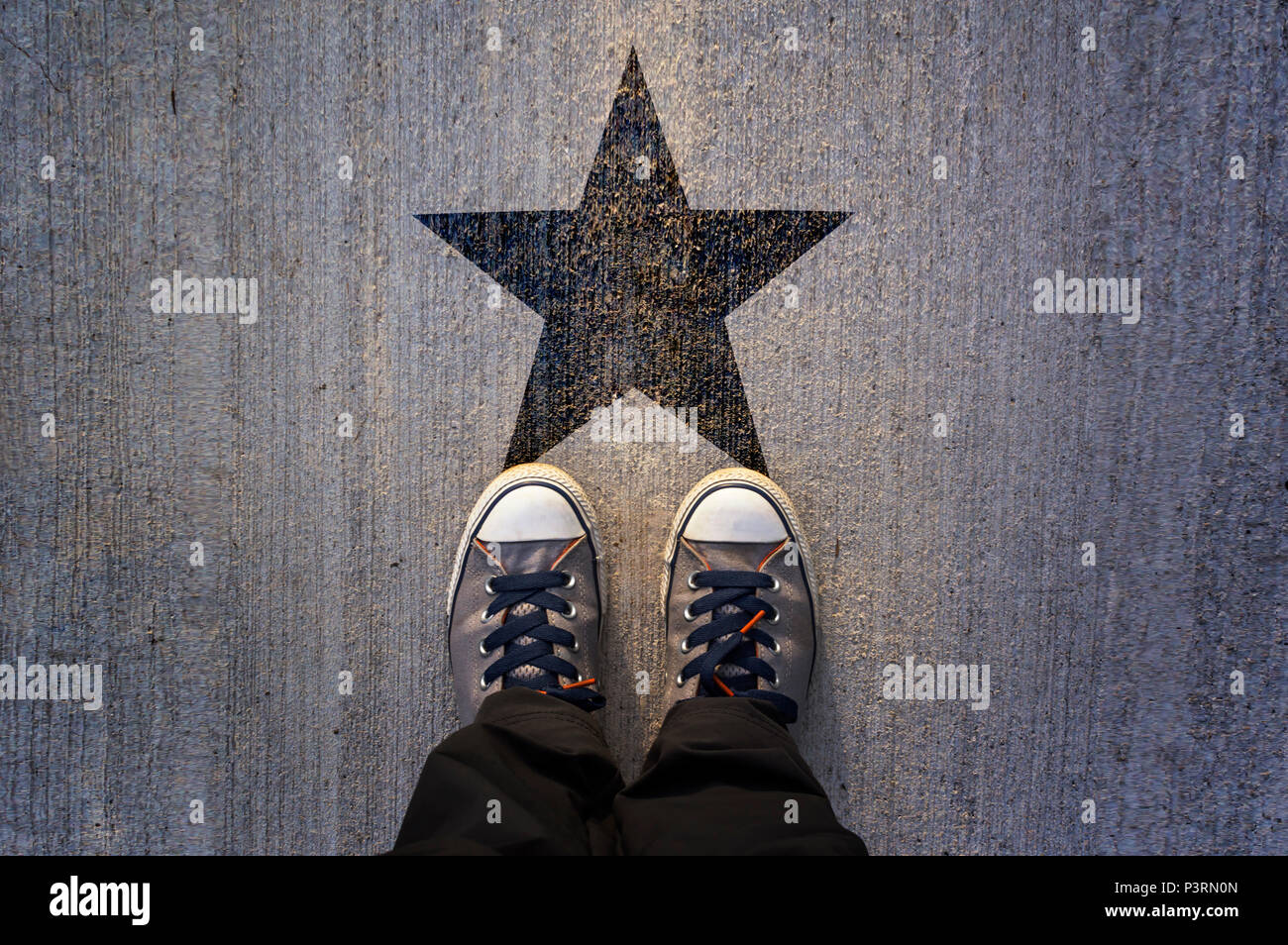 Sneakers on asphalt road with black star shape, vip, prize and award ...