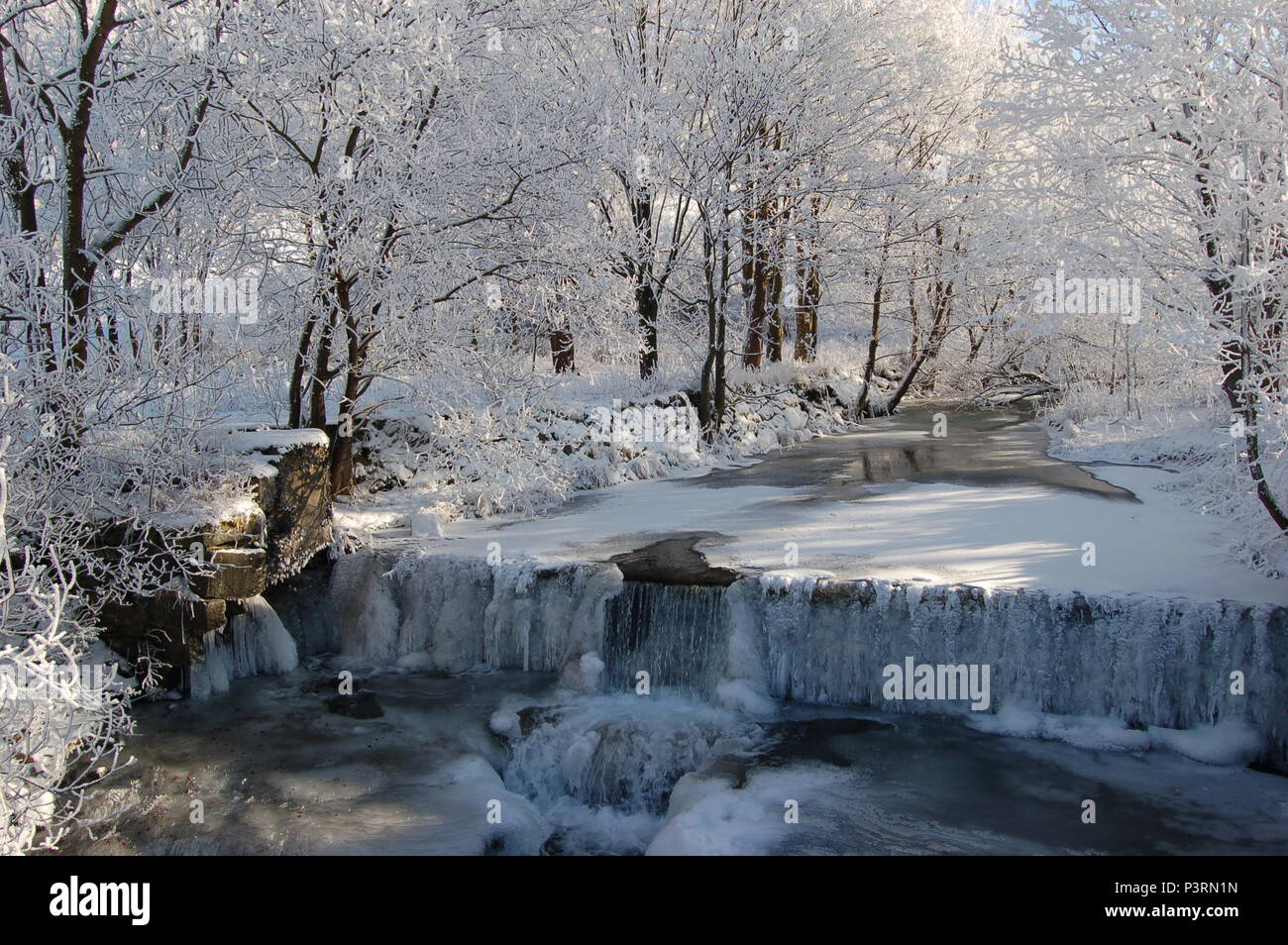 Snow covered Biała Lądecka creek and waterfall in the village of ...