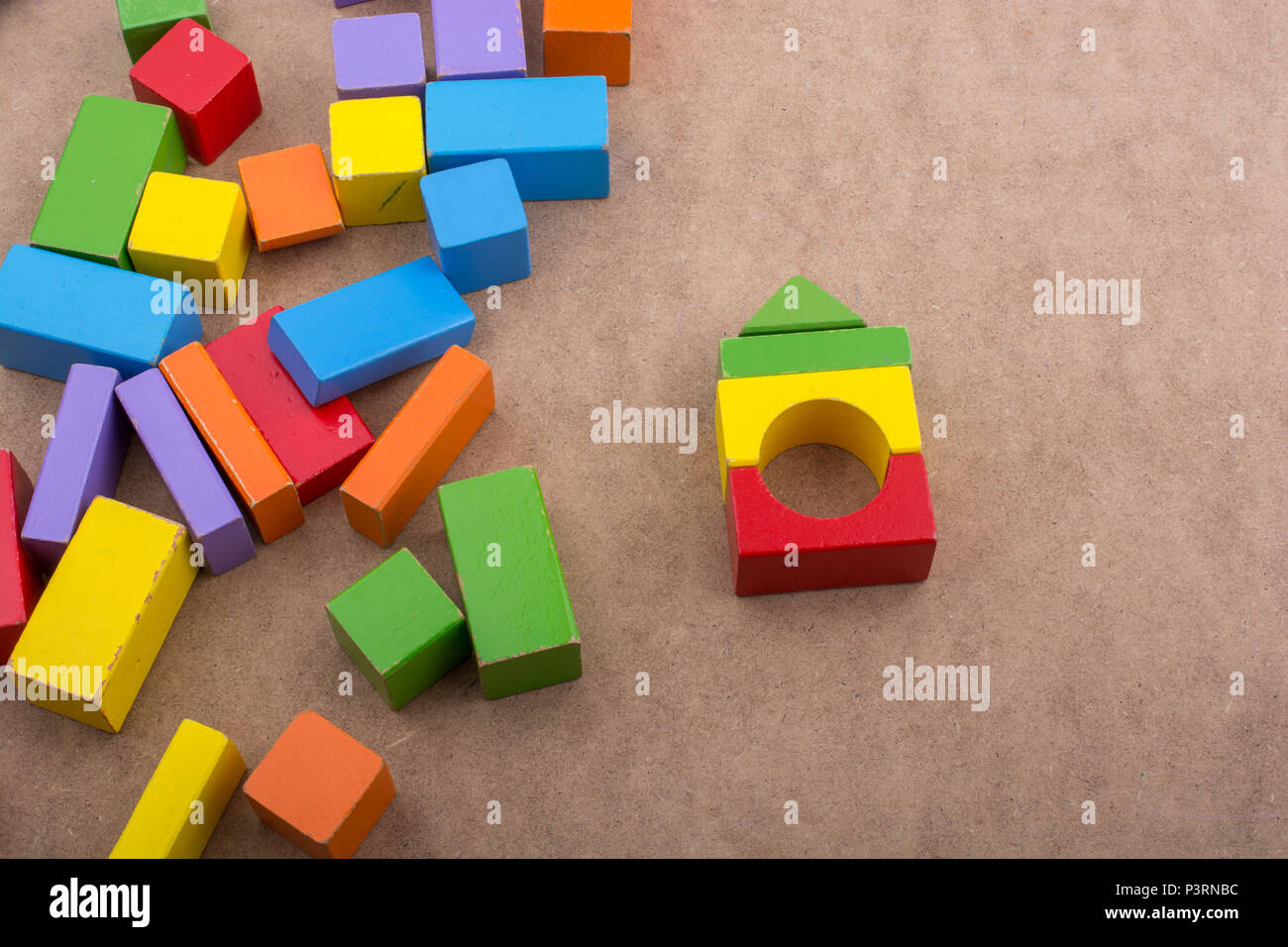 House shape formed out of building blocks on a brown background Stock ...