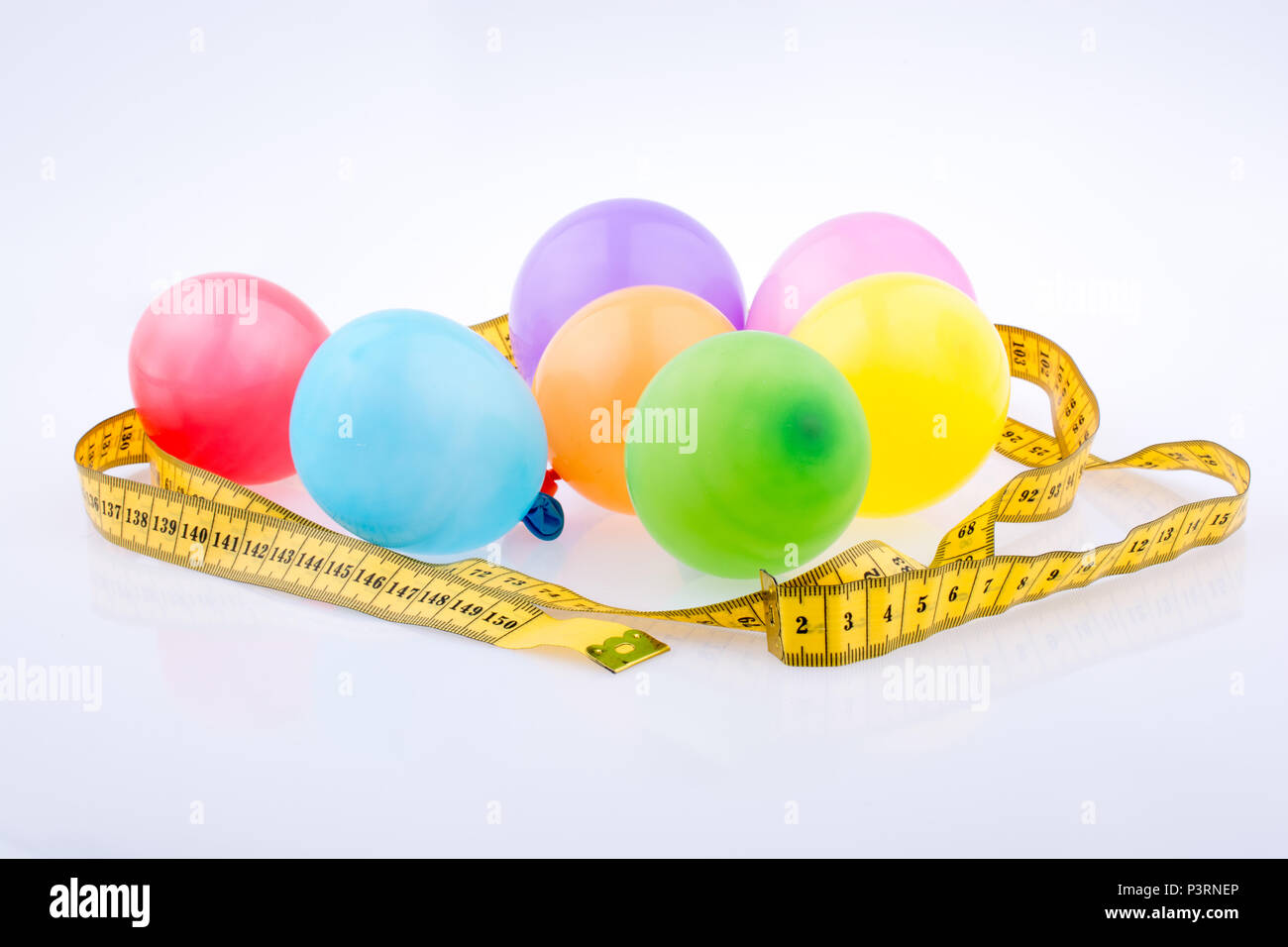 Colorful balloons surrounded by measuring tape with happy celebration ...