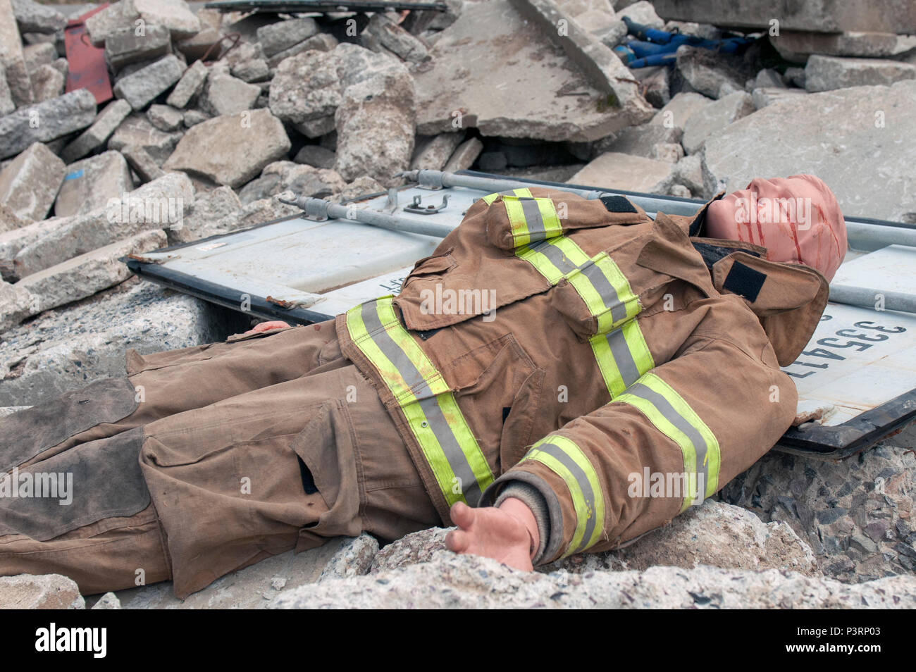 A mannequin set up by site support lies in the rubble pile at the ...