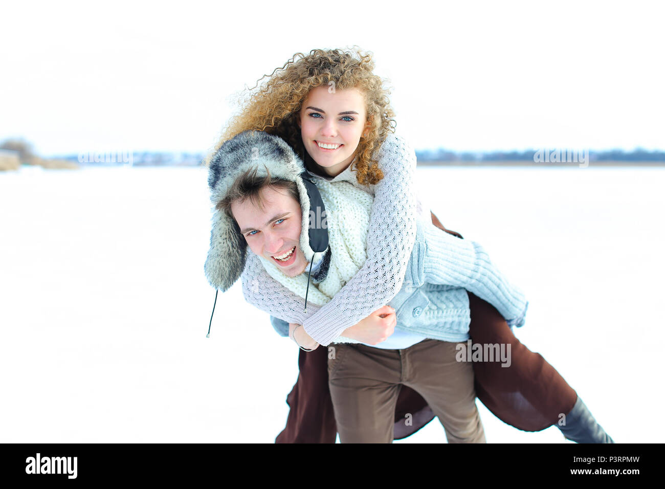 Happy man picking up woman in white monophonic background Stock Photo ...