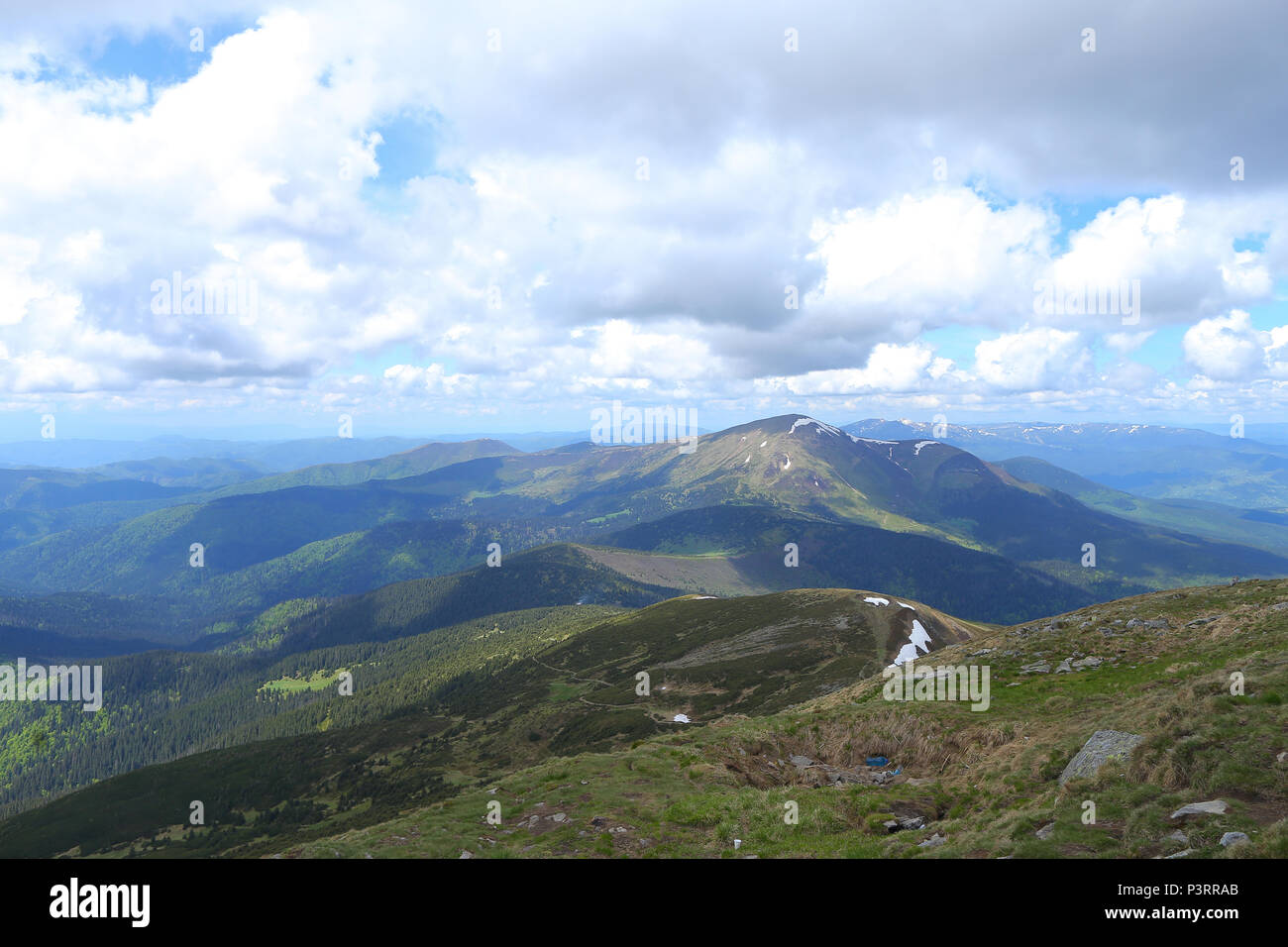 Amazing green Alps mountains and clouds in background Stock Photo - Alamy