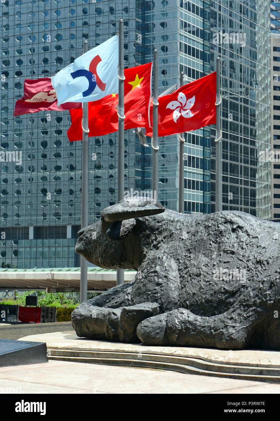 HONG KONG CIRCA JUNE 2018. Bull sculptures and flags flying outside ...