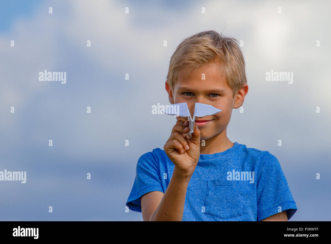 Child throwing paper plane hi-res stock photography and images - Alamy
