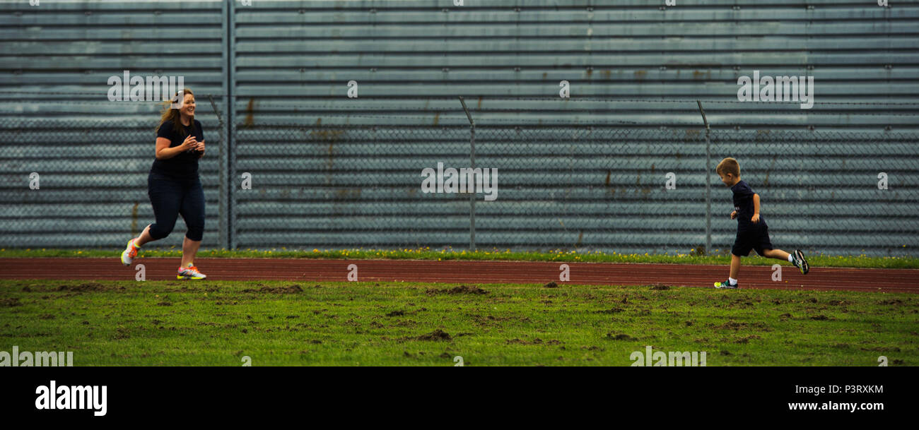 Jennifer Hartzog, cancer survivor, runs with her son Sam Hartzog during ...