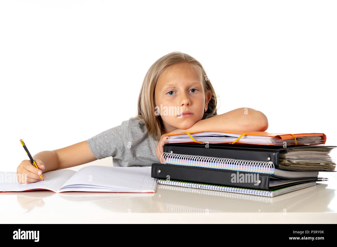 Tired young cute blonde haired schoolgirl with learning difficulties ...
