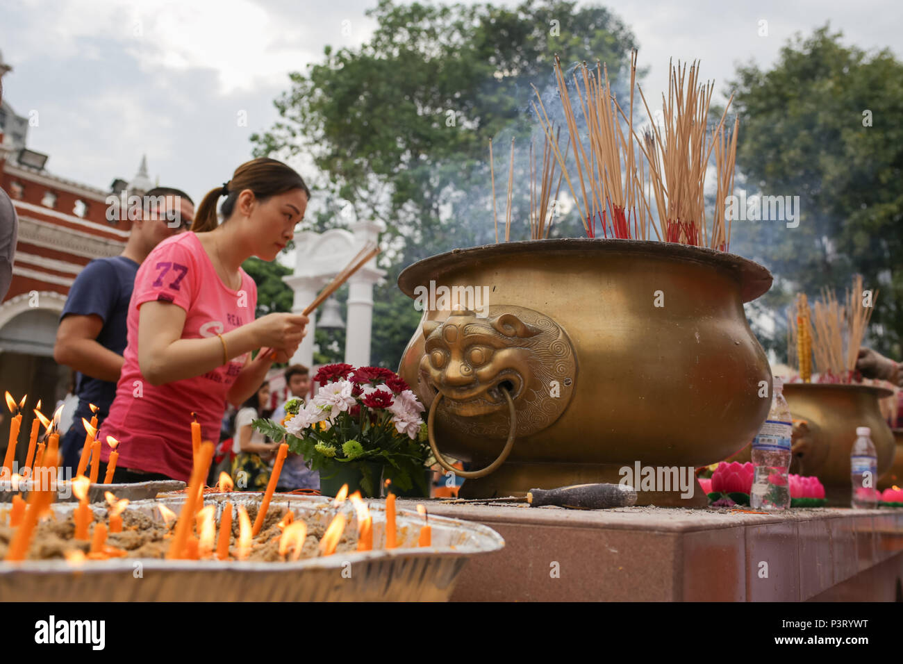 Female buddhists praying with joss sticks and lotus candles at Maha ...
