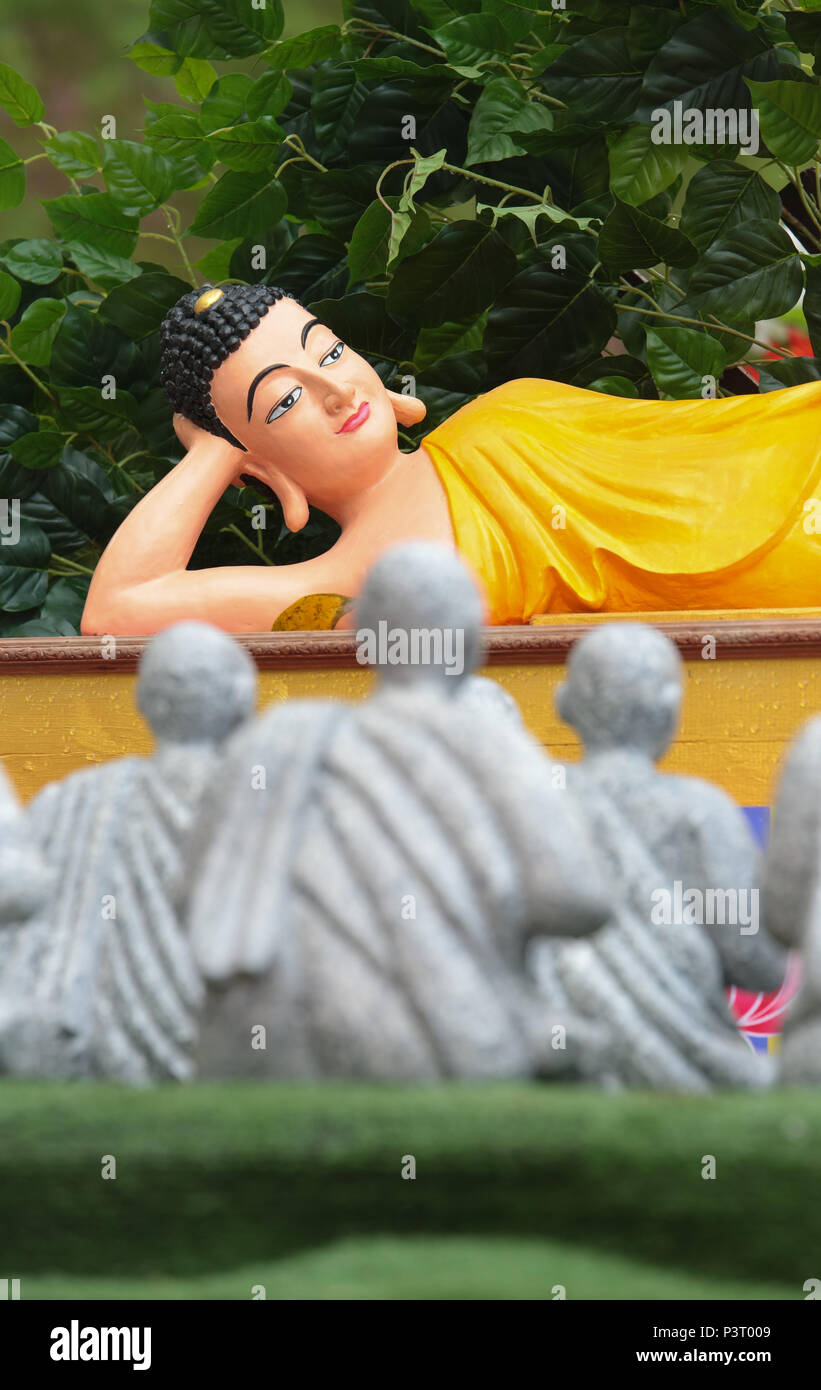 Sleeping buddha and his follower statues on the wesak procession floats ...