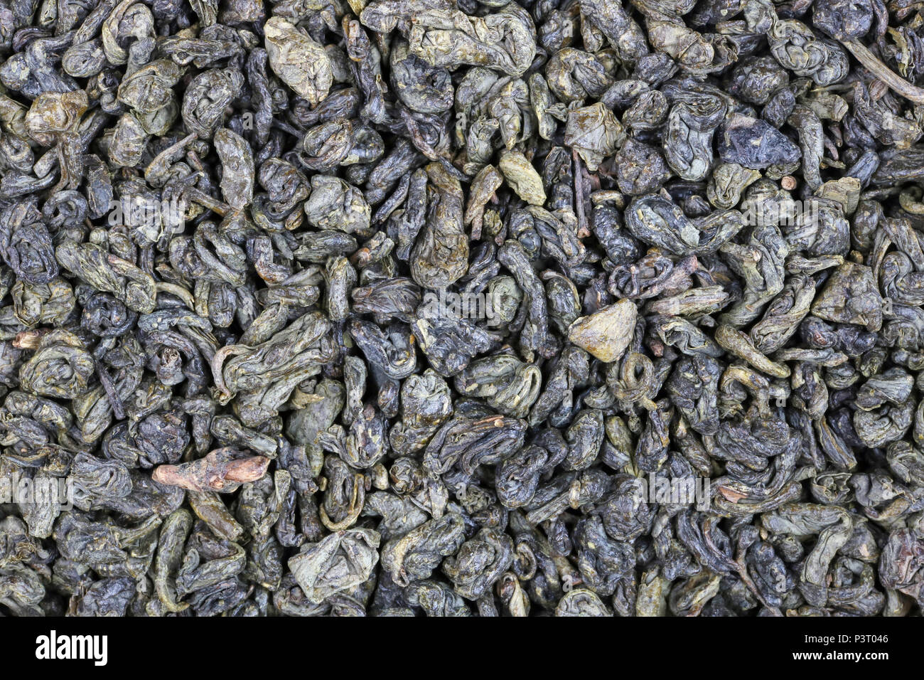 Micro granules of dry elite green tea macro background Stock Photo - Alamy