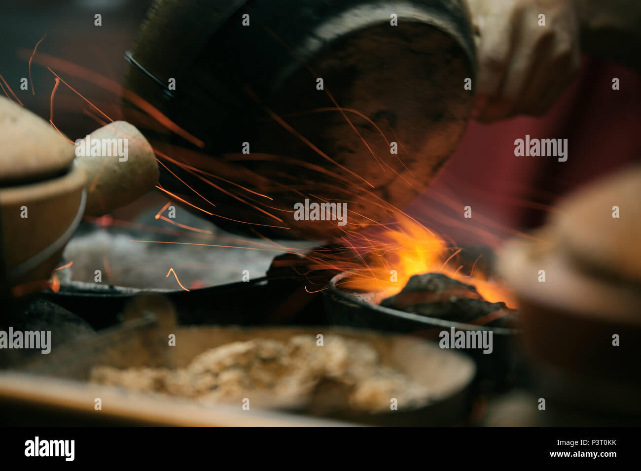 Meal preparation using clay pot on charcoal fire Stock Photo - Alamy