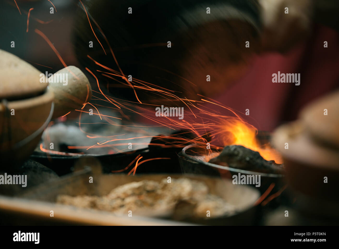 Meal preparation using clay pot on charcoal fire Stock Photo - Alamy