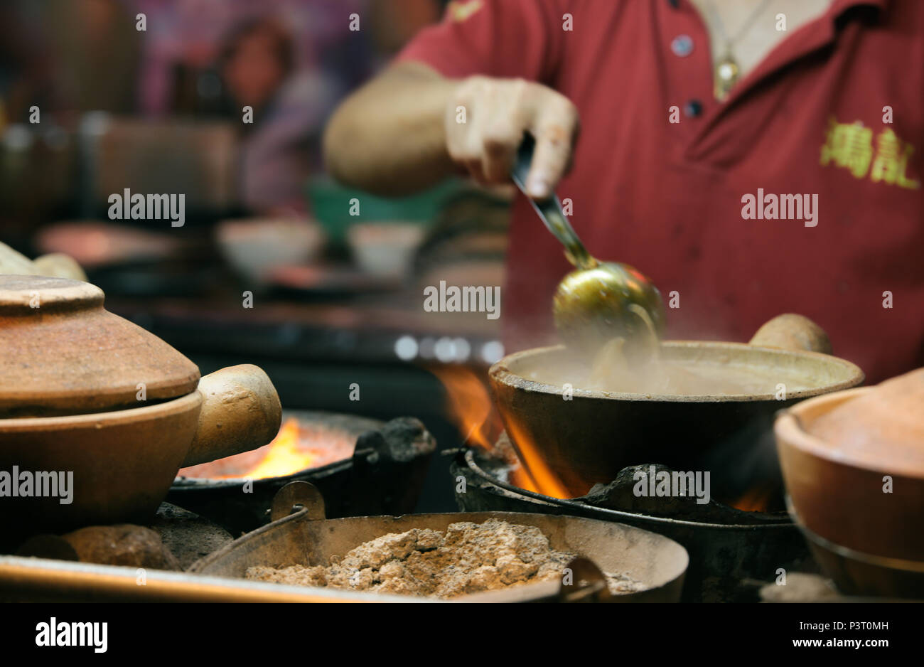 Meal preparation using clay pot on charcoal fire Stock Photo - Alamy